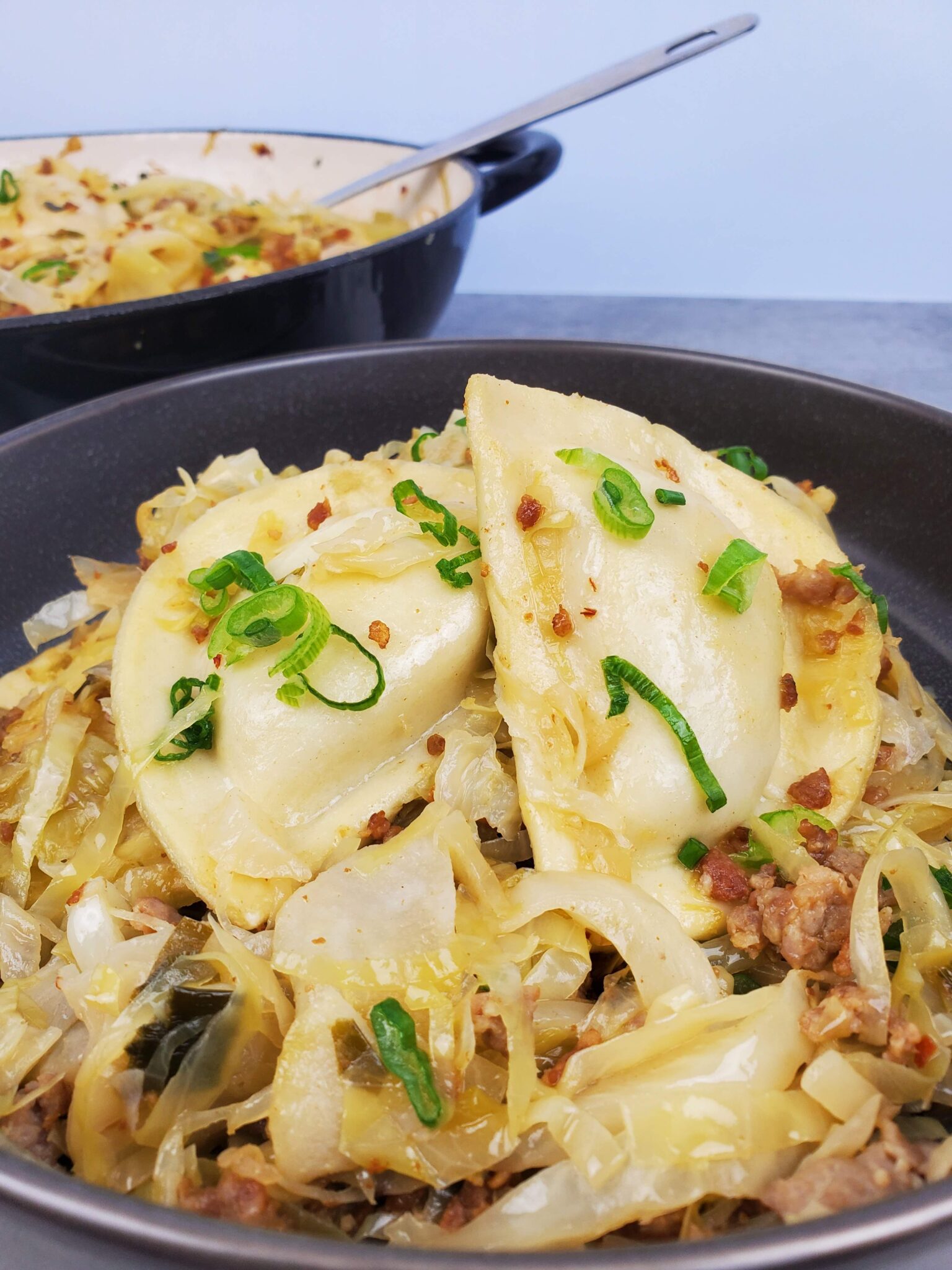 Pierogi Bowl with Cabbage Pears and Sausage - Women of Today